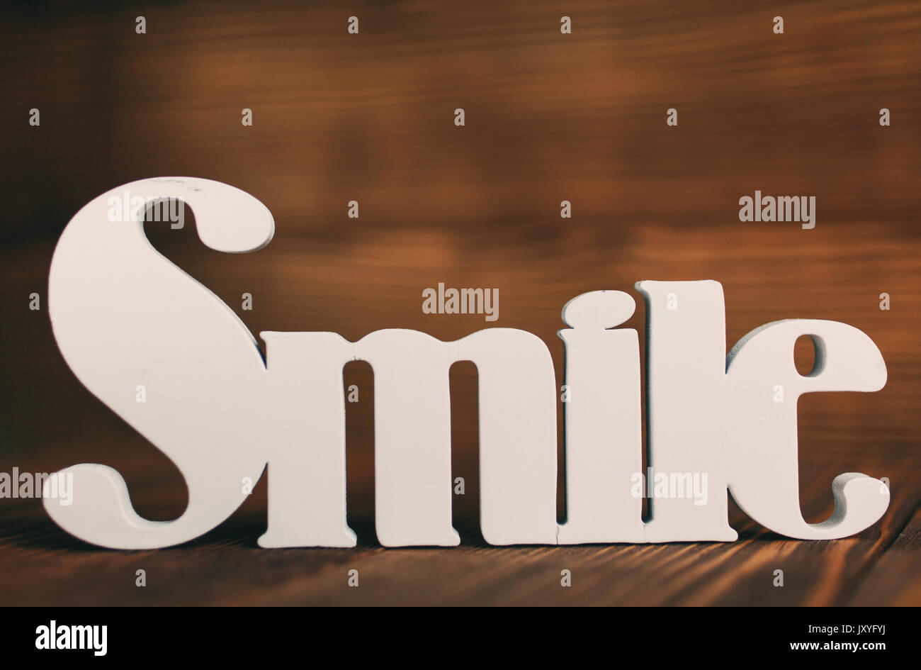 word, smile and motivation concept - smile text on wooden background ...