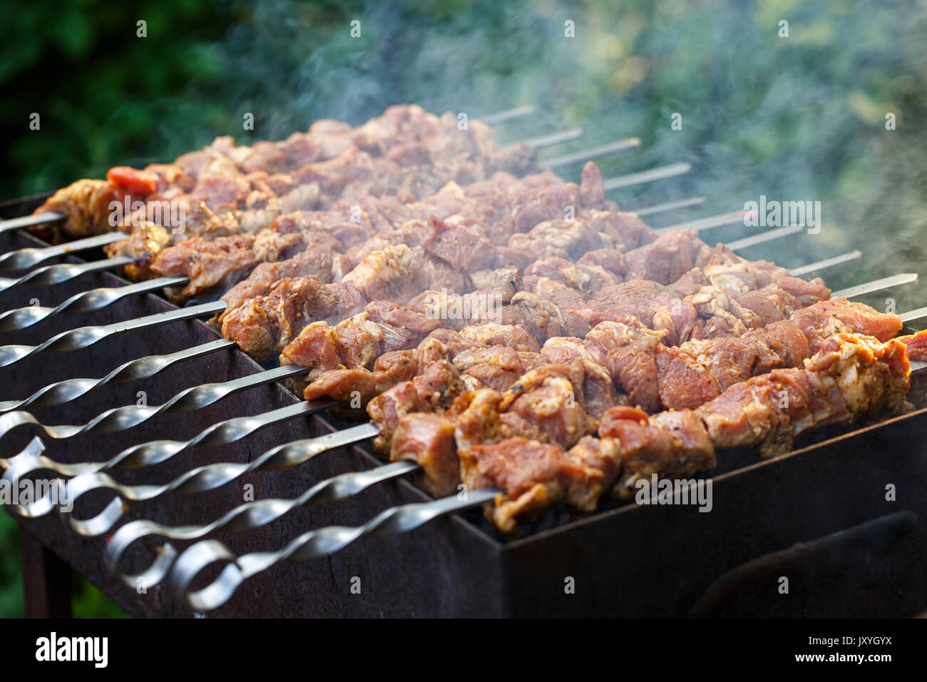 hiking, cooking in the forest and outdoor activities concept - meat on ...