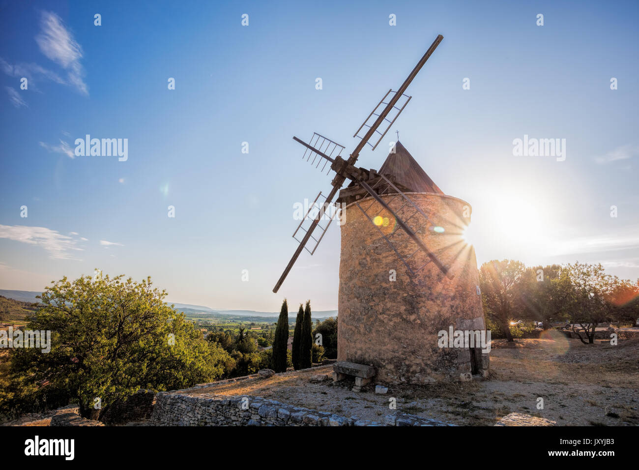 Old stone windmill against sunset in Saint Saturnin les Apt, Provence ...