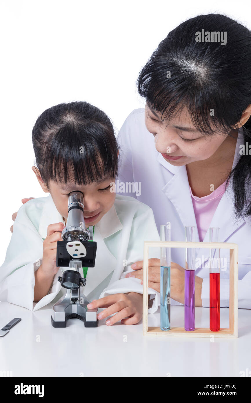 Asian Chinese teacher and little student girl working with microscope ...