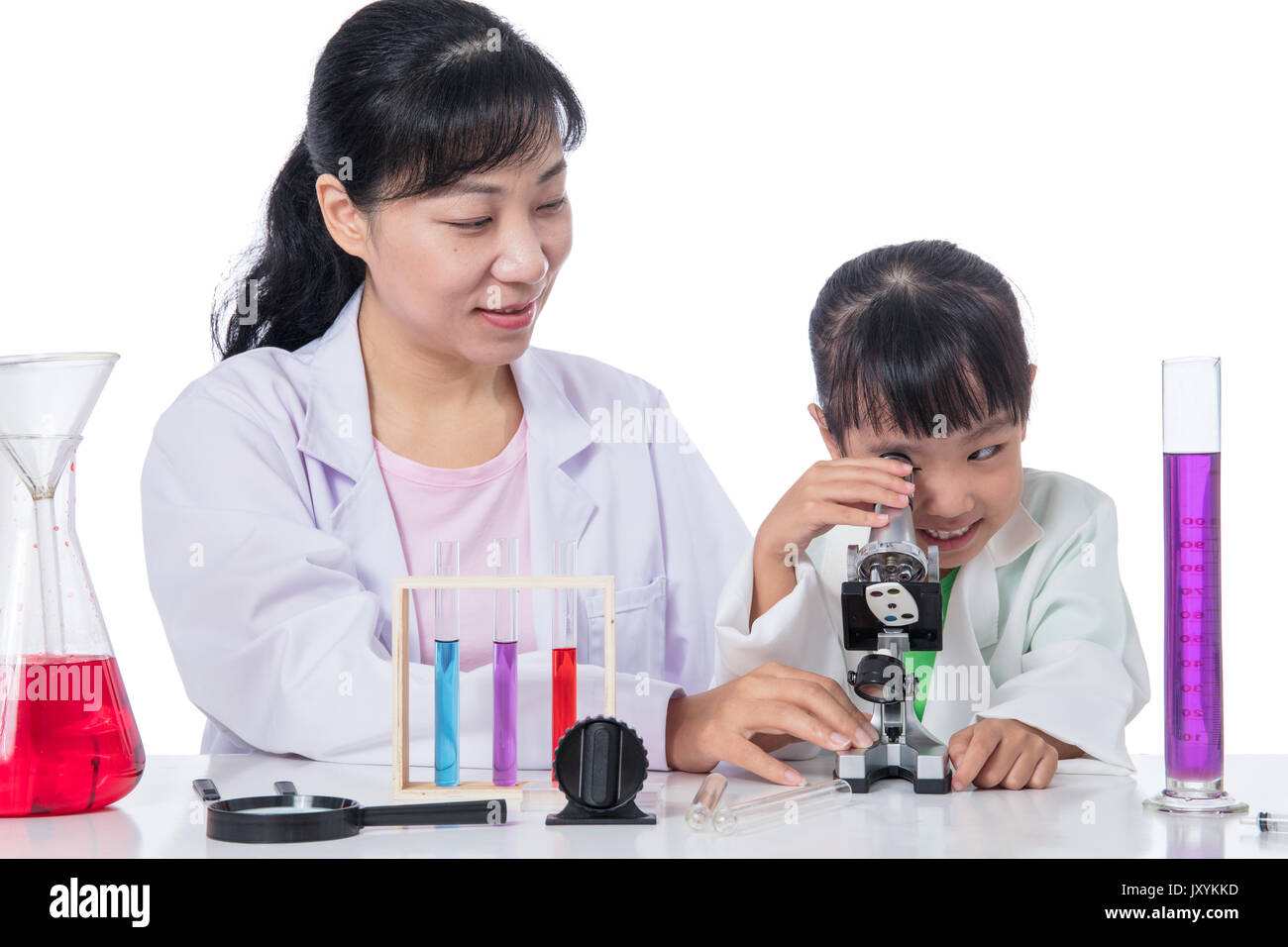 Asian Chinese teacher and little student girl working with microscope ...