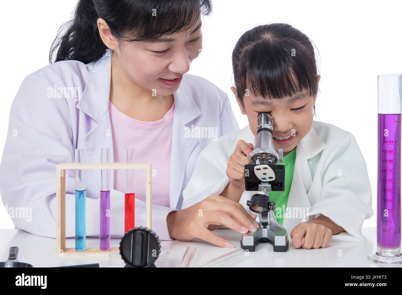 Asian Chinese teacher and little student girl working with microscope ...