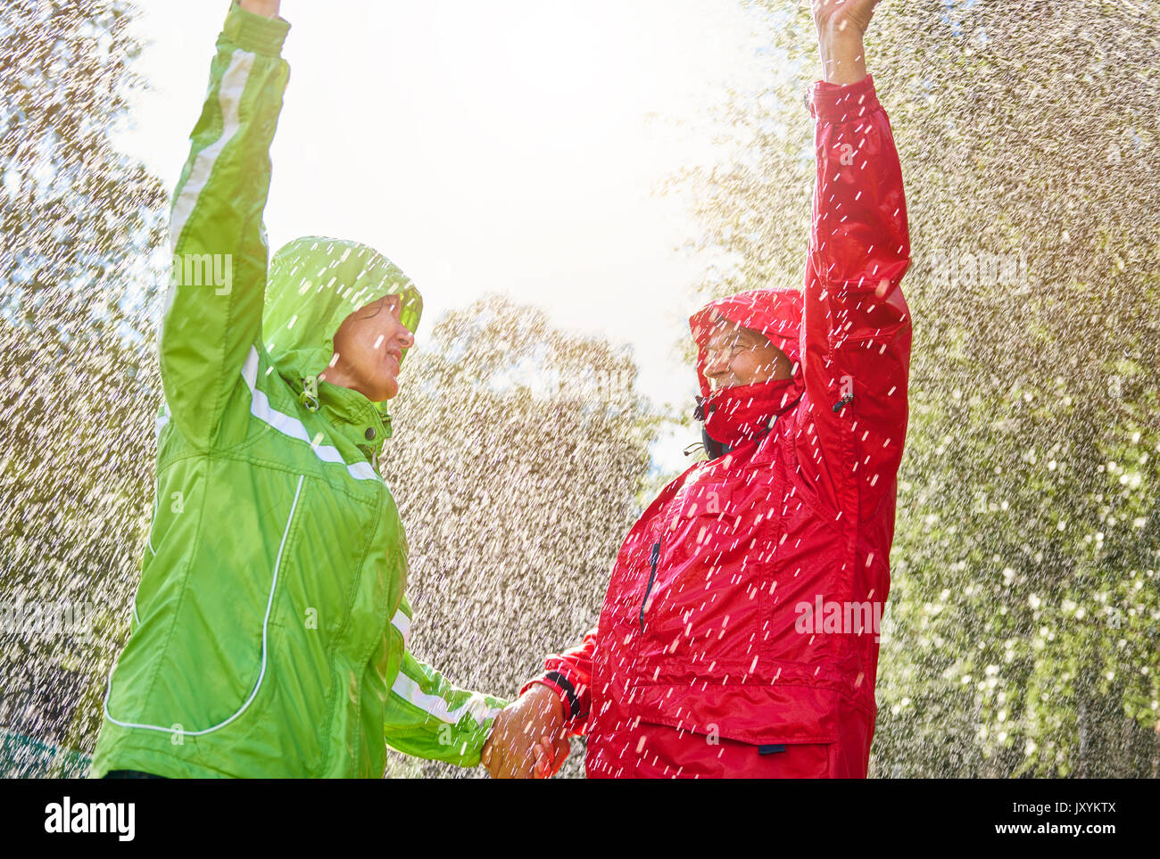 Couple holding hands in the rain Stock Photo - Alamy