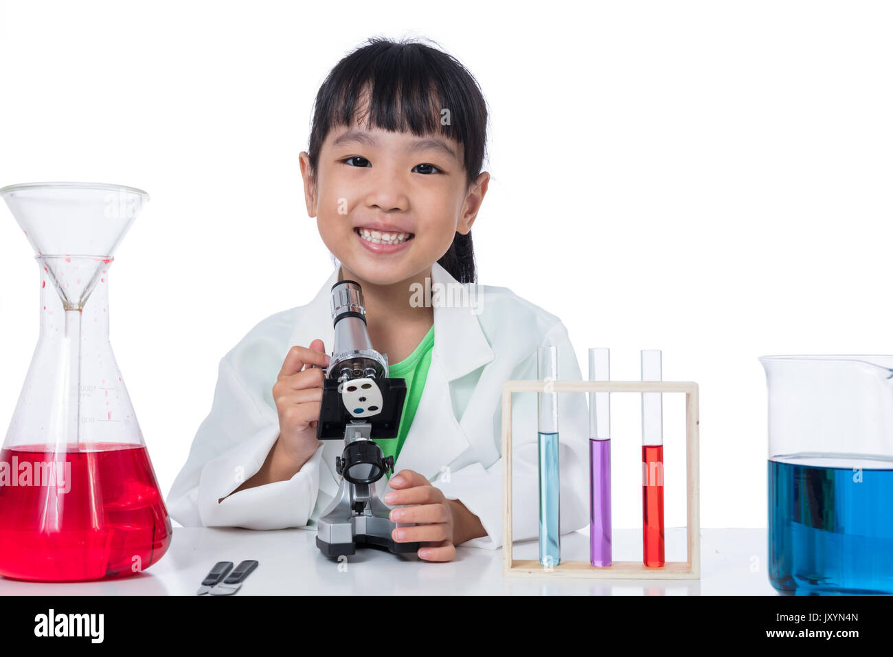 Asian Chinese little girl working with microscope in isolated white ...