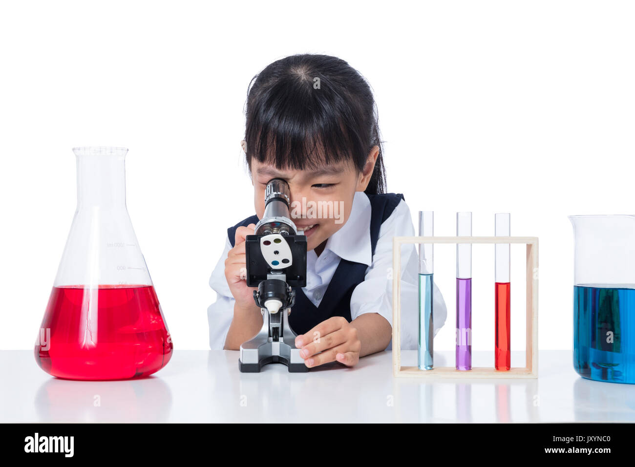 Asian Chinese little girl working with microscope in isolated white ...