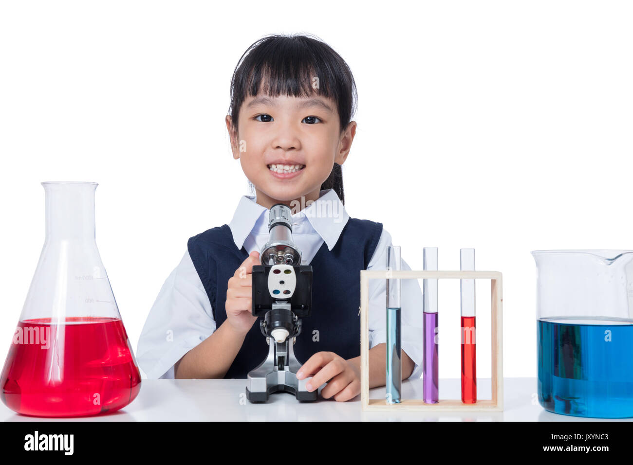 Asian Chinese little girl working with microscope in isolated white ...