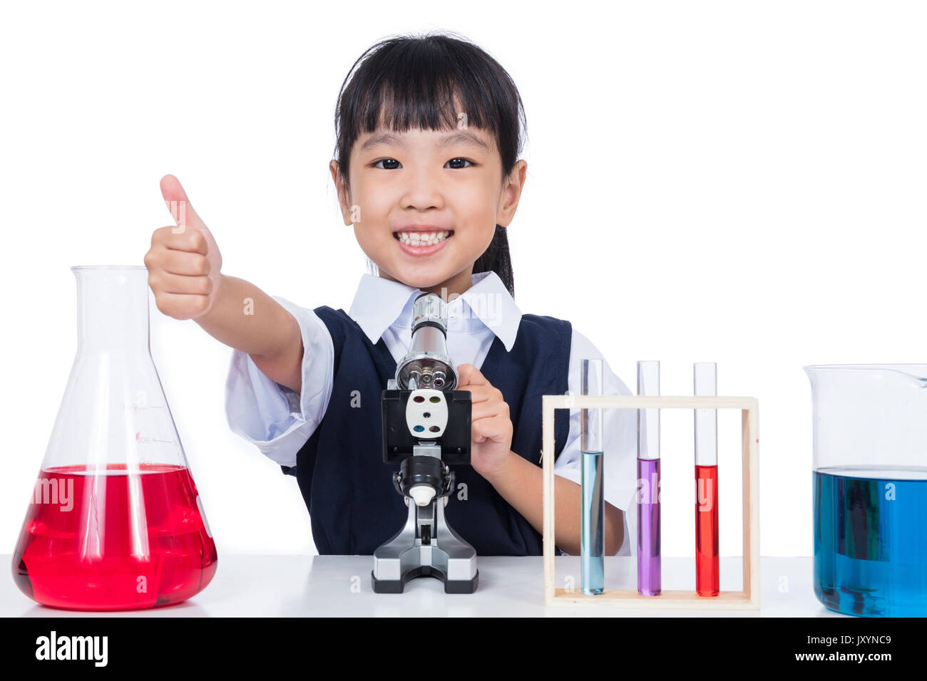 Asian Chinese little girl working with microscope in isolated white ...