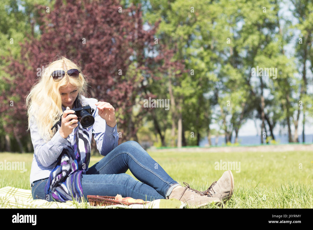 Professional woman photographer taking outdoor with prime lens, during ...