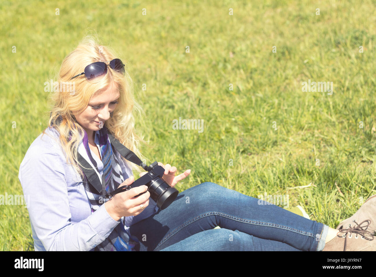Professional woman photographer taking outdoor with prime lens, during ...