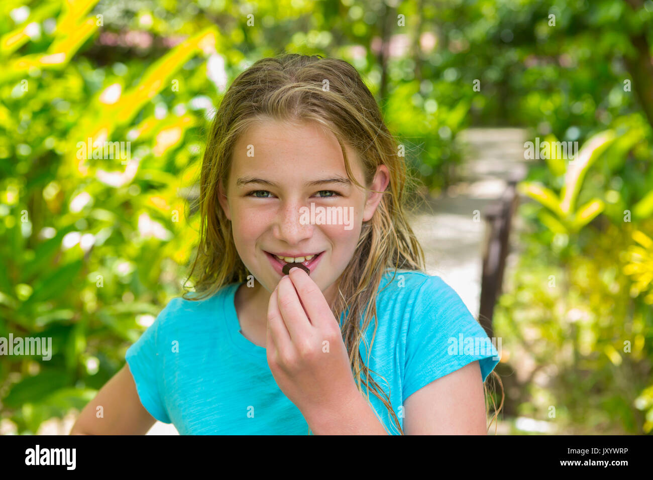 Caucasian girl eating snack Stock Photo - Alamy