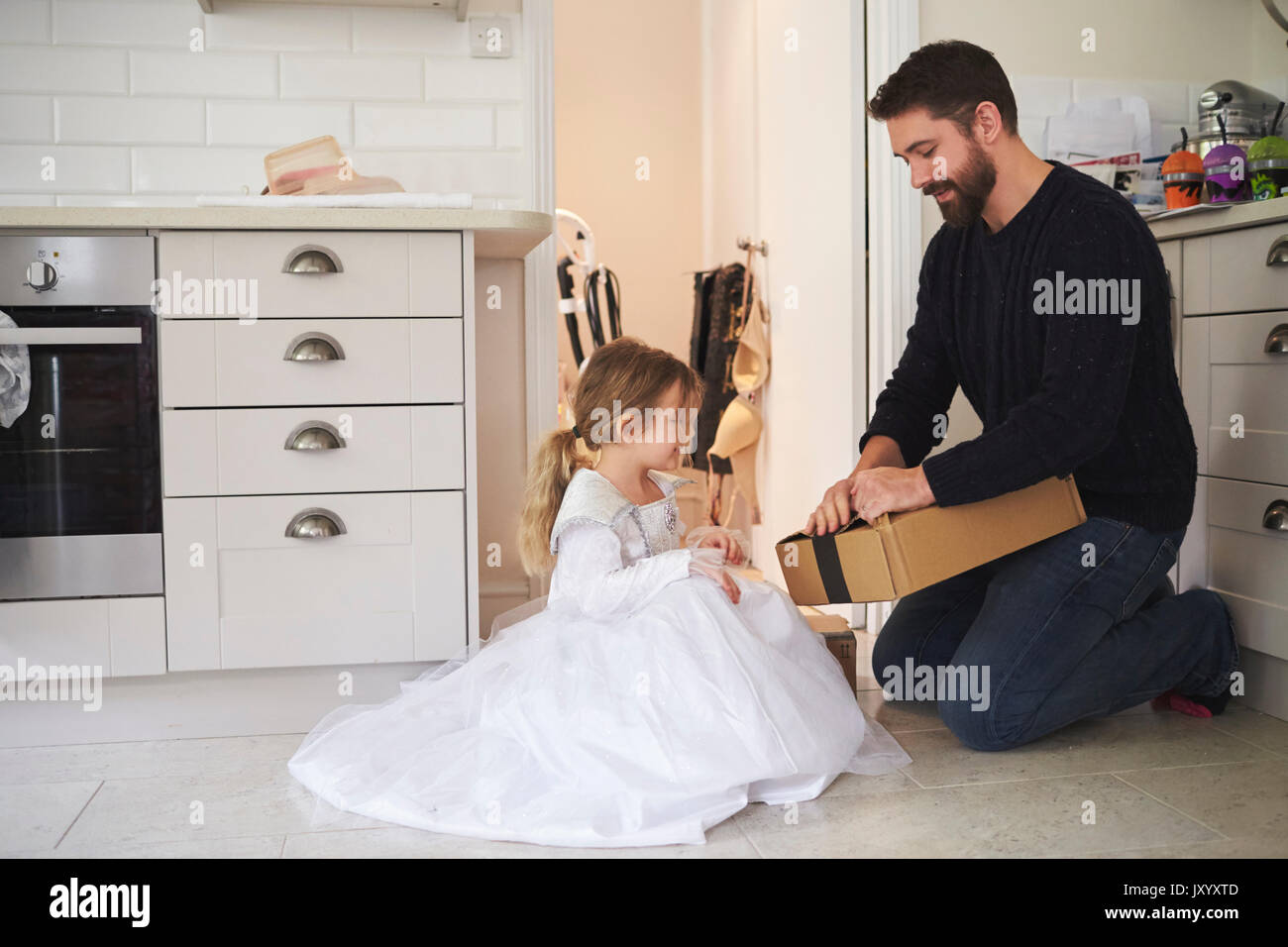 Father And Daughter Opening Home Delivery Package Stock Photo - Alamy