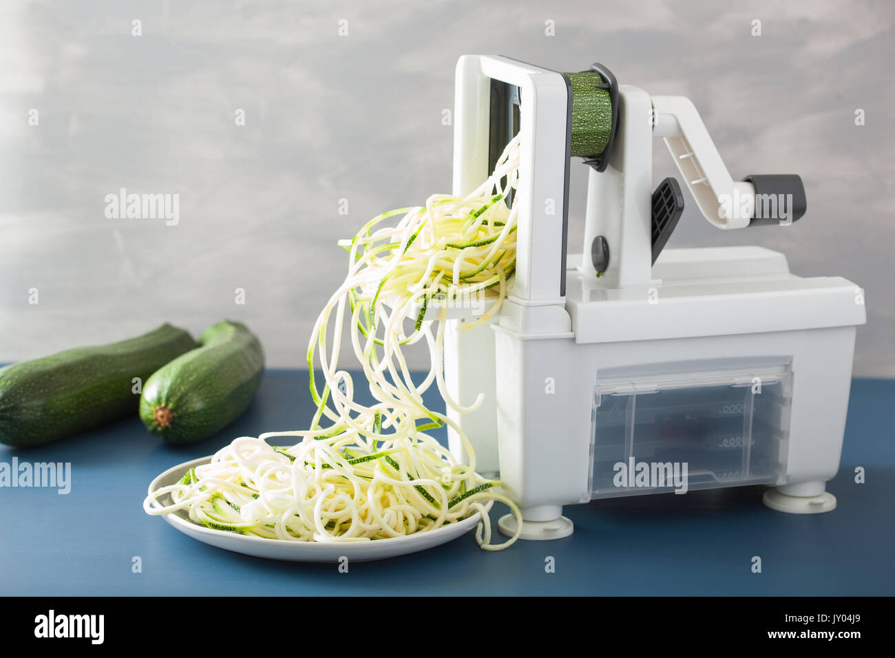 spiralizing courgette raw vegetable with spiralizer Stock Photo - Alamy