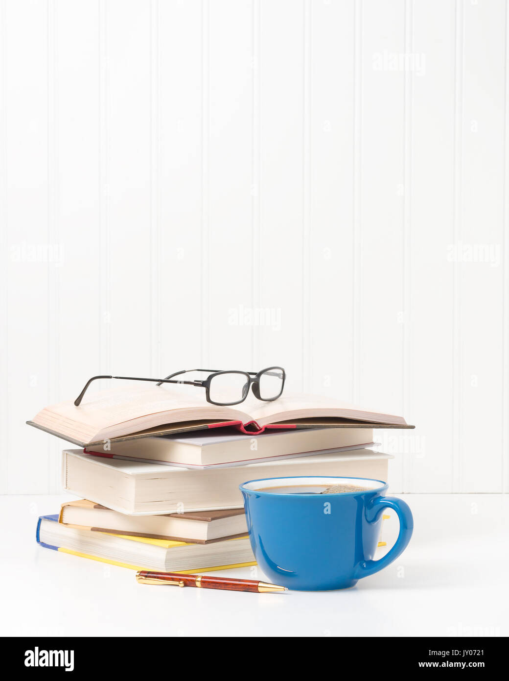Small stack of textbooks and a cup of fresh coffee Stock Photo - Alamy