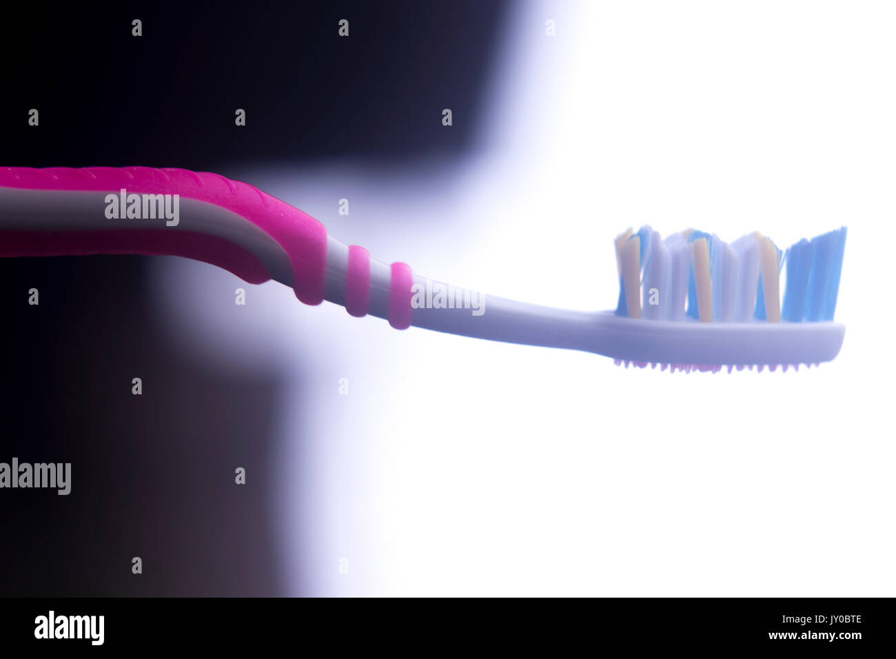 Manual modern tooth brush closeup on plain background Stock Photo - Alamy
