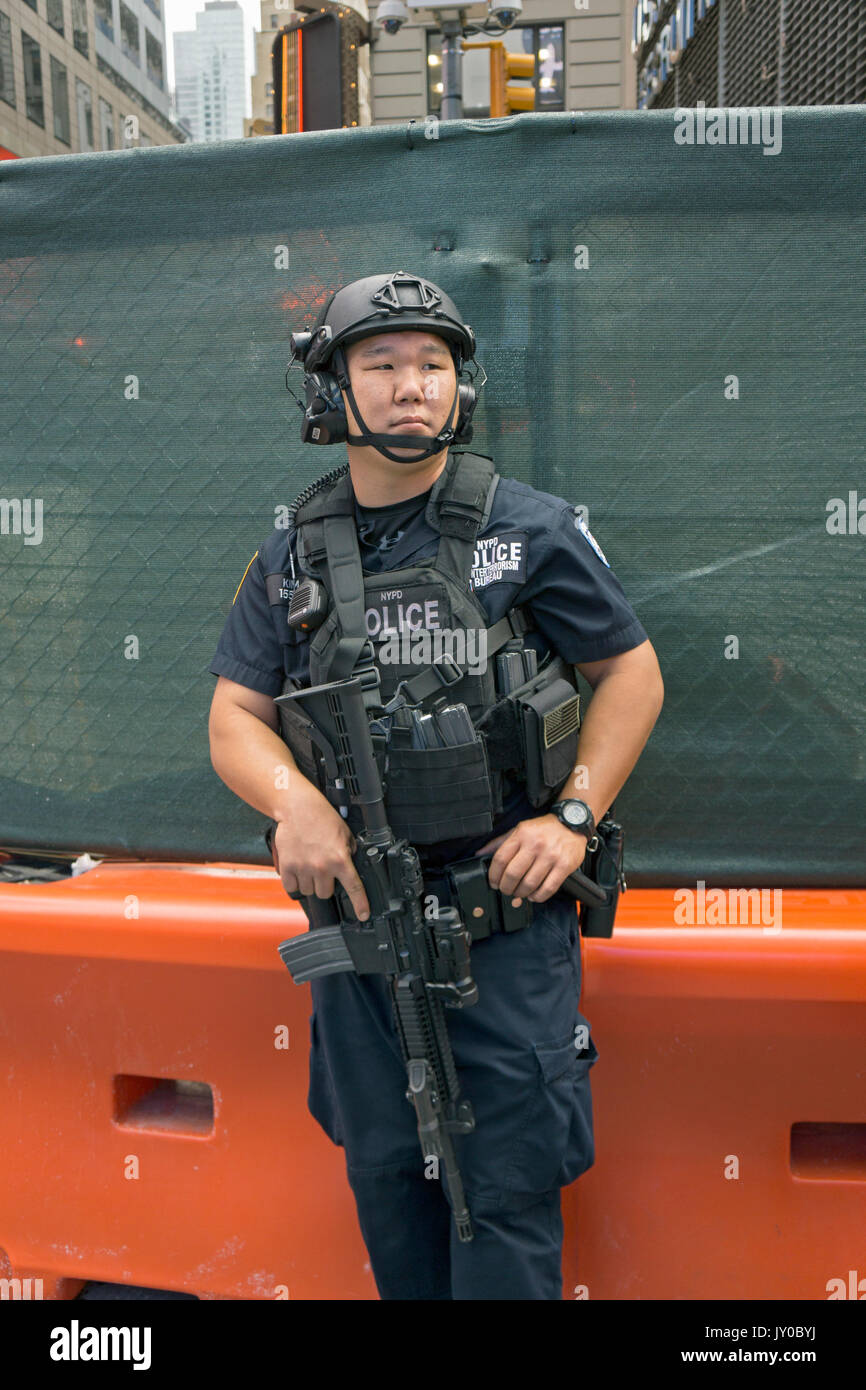 An armed Asian American counterterrorism policeman on patrol in Times ...
