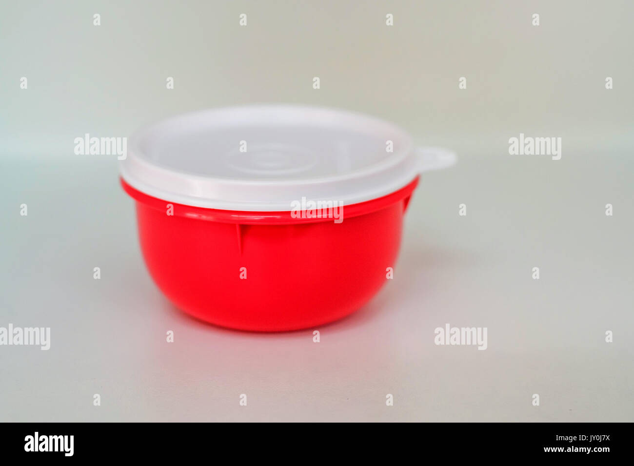 Modern red food container with lid isolated Stock Photo - Alamy