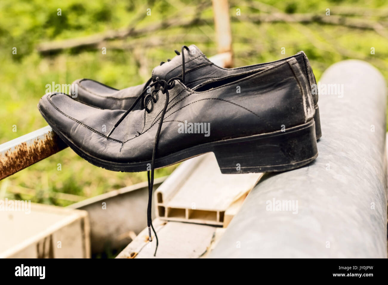Old black men shoes like symbol of time and past Stock Photo - Alamy