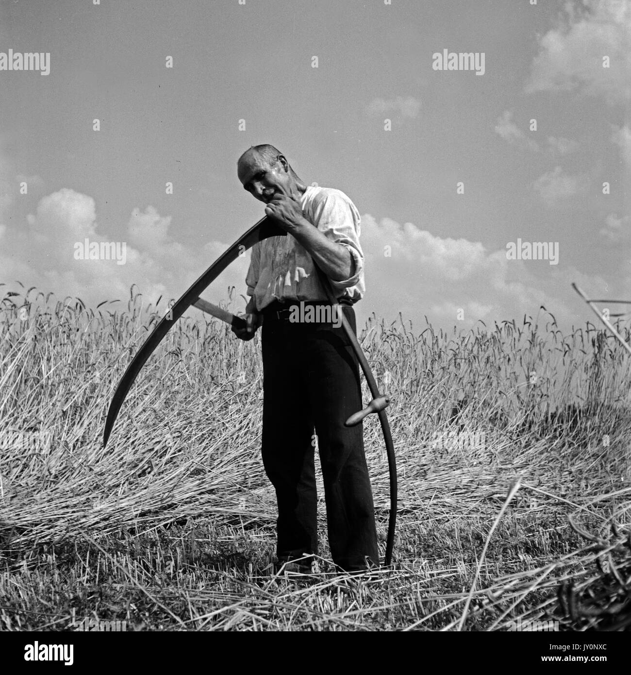 Farmer Scythe Black and White Stock Photos & Images - Alamy