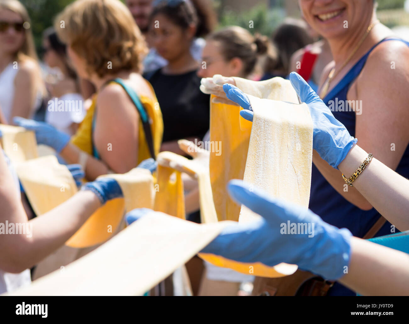 Homemade long pasta at the celebration of the festival with visitors ...