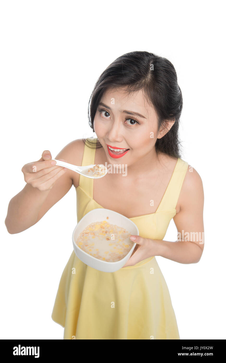 Asian woman eating bowl of cereal or muesli for breakfast Stock Photo ...