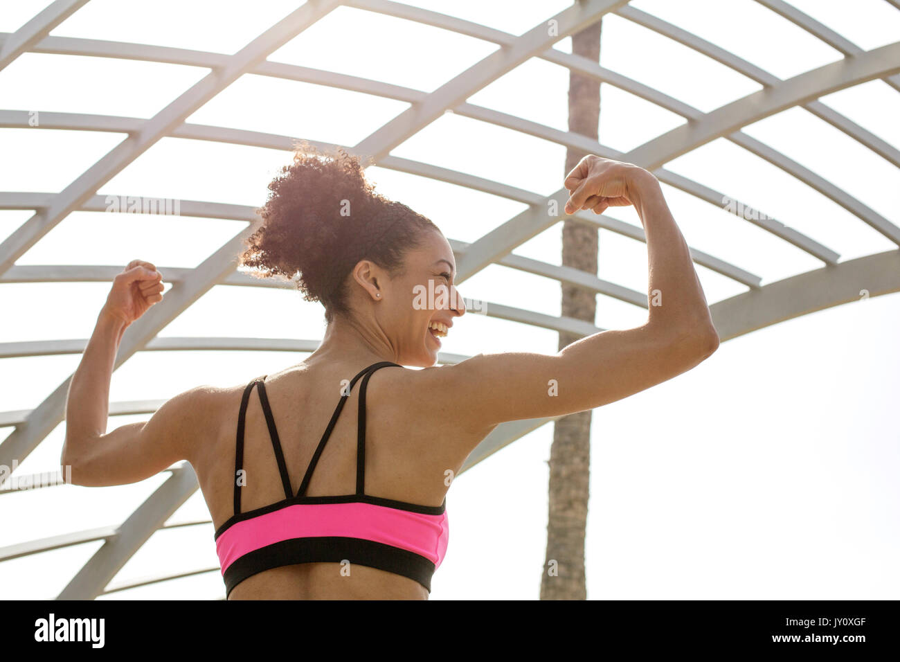 Mixed Race woman flexing arms Stock Photo - Alamy