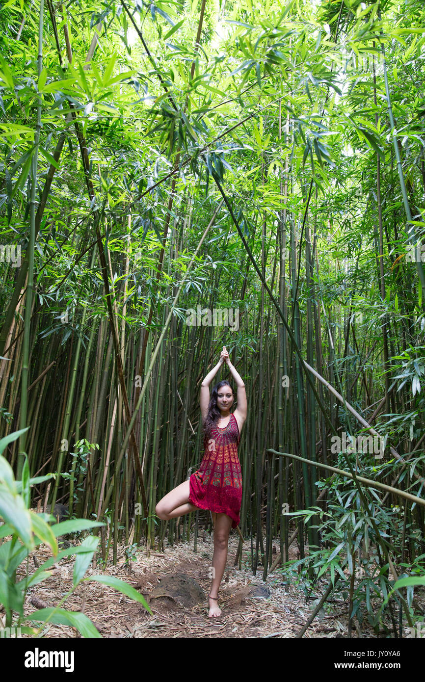Caucasian woman standing in bamboo forest performing yoga Stock Photo ...