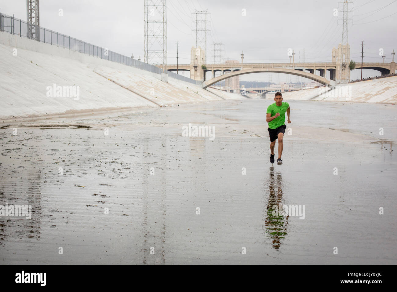 Mixed Race man running in canal Stock Photo - Alamy