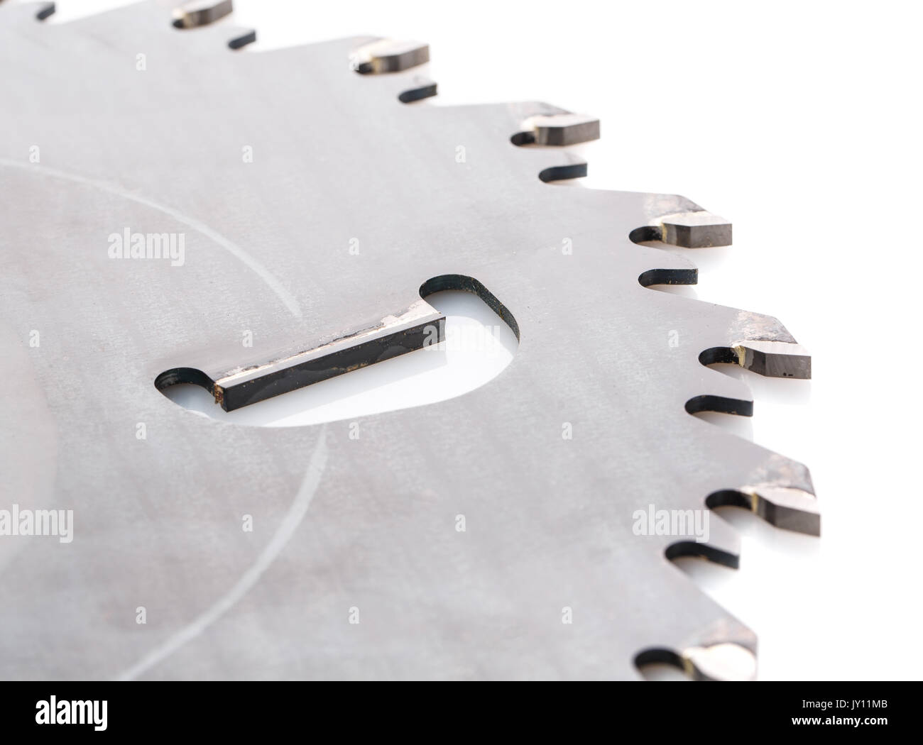 The tips of the teeth of a new ripping saw blade on a white background ...