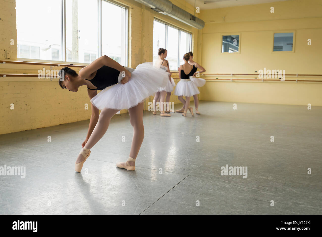 Girl checking shoe in ballet studio Stock Photo - Alamy