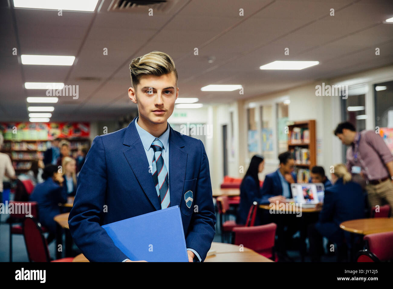 Male student school uniform holding hi-res stock photography and images ...