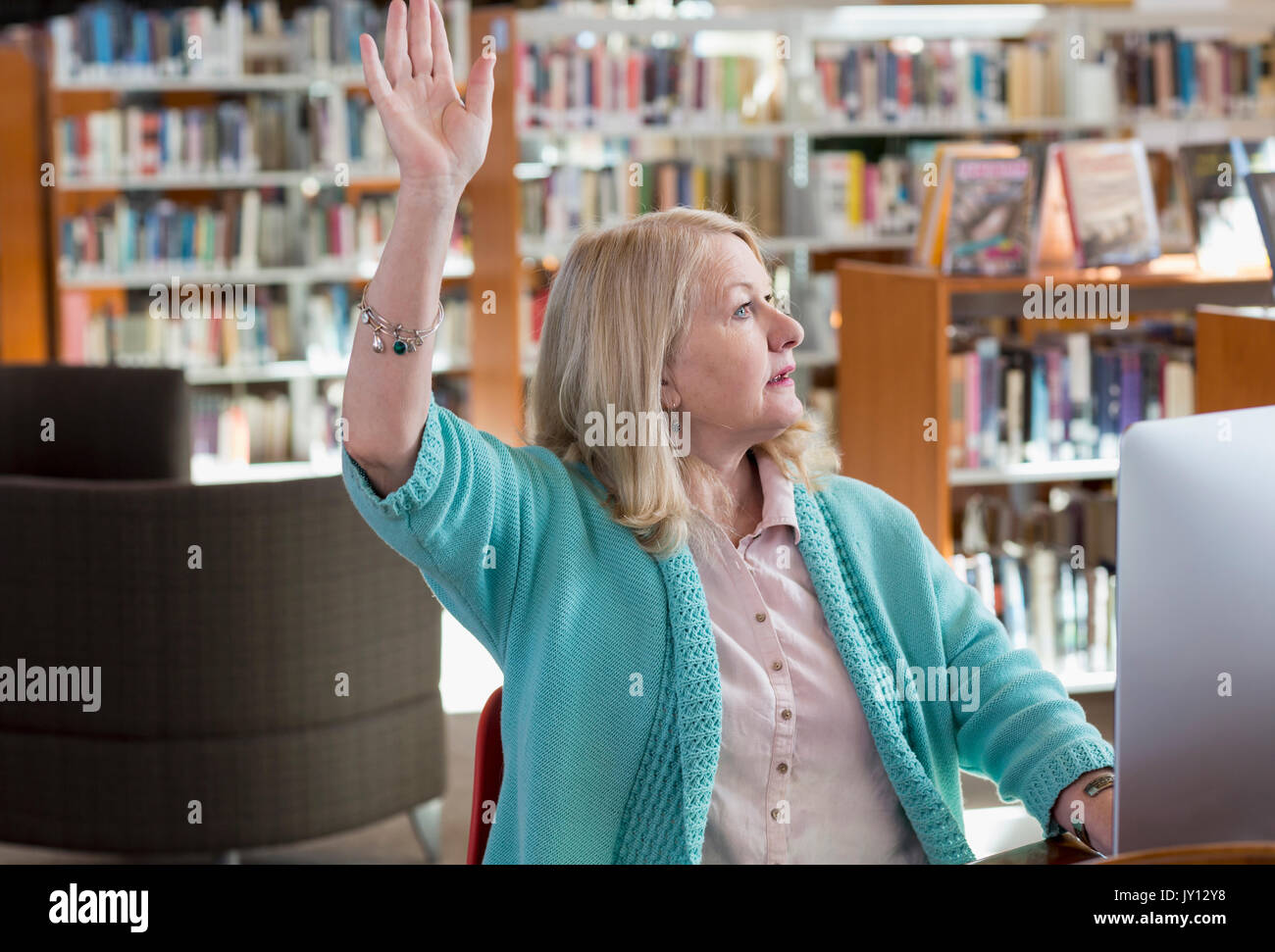 Woman raising hand hi-res stock photography and images - Alamy