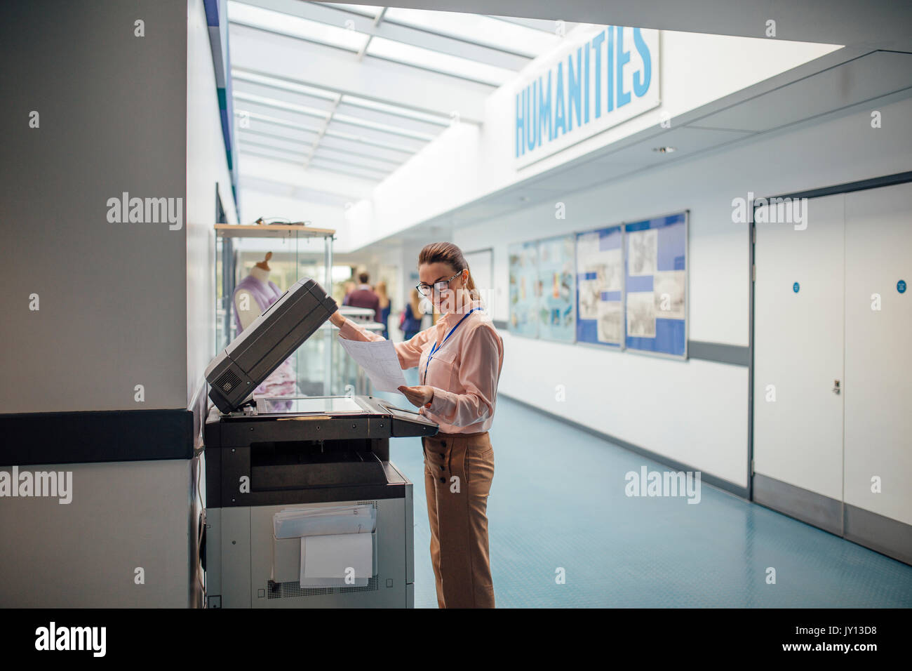 Teacher is printing off work sheets for her next lesson using the ...
