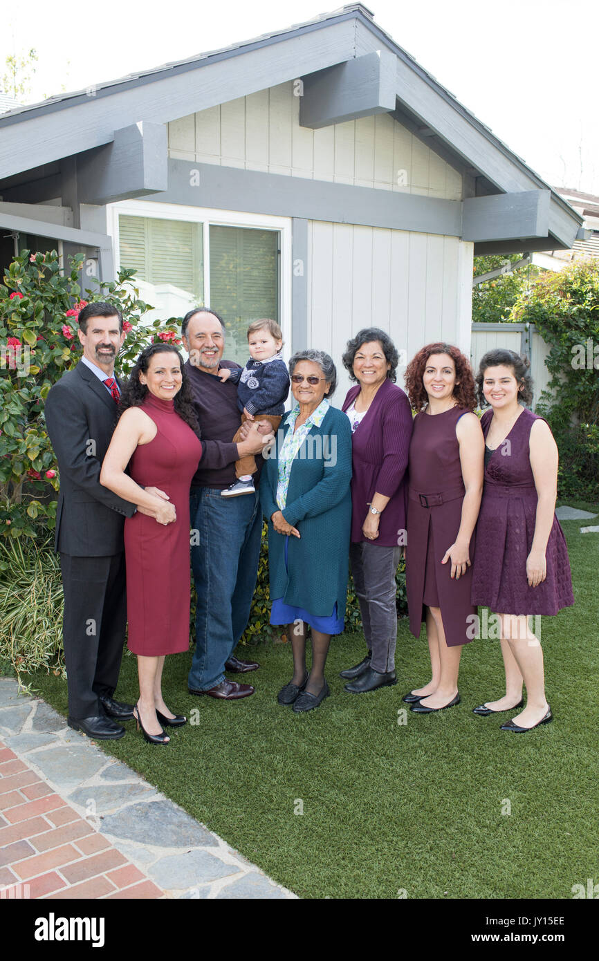 Multi-generation family posing near house Stock Photo - Alamy