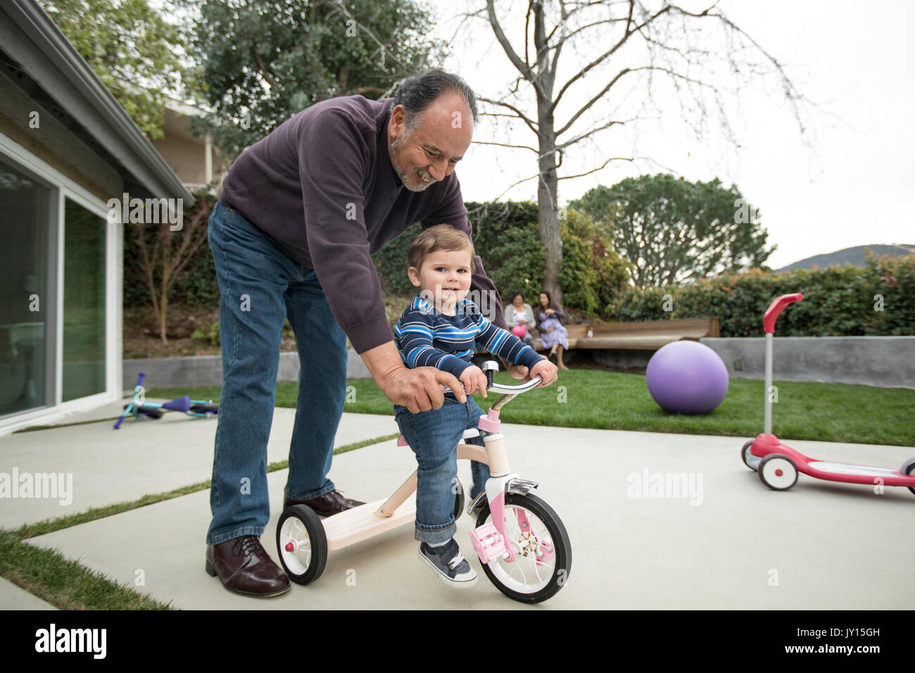 Kids on tricycle hi-res stock photography and images - Alamy