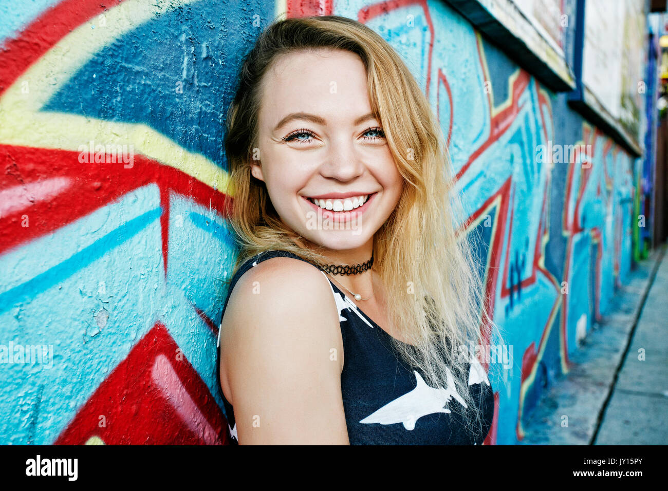Lady leaning on wall hi-res stock photography and images - Alamy