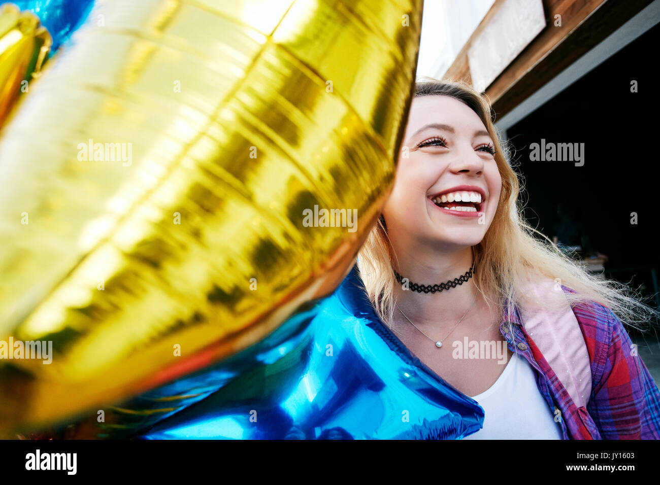 Portrait of Caucasian woman laughing and holding balloon Stock Photo ...