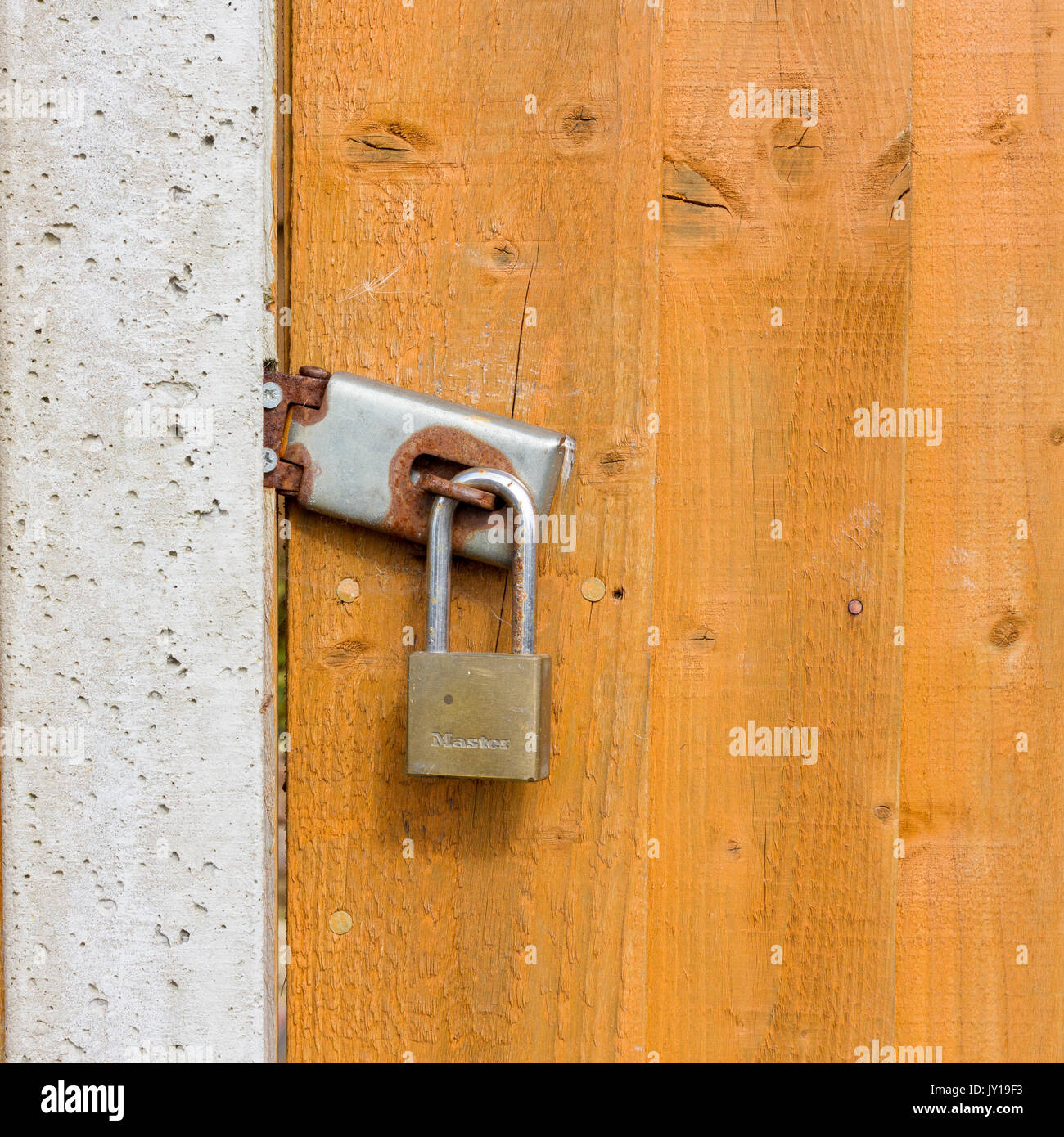 Close up of a wooden garden gate secured with a padlock Stock Photo - Alamy
