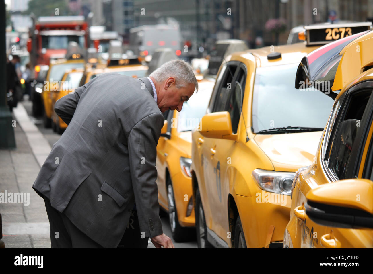 City Worker loading a cab Stock Photo - Alamy