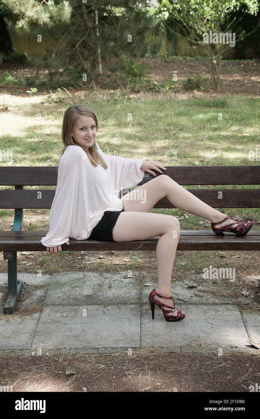 pretty girl on a park bench in the summer Stock Photo - Alamy