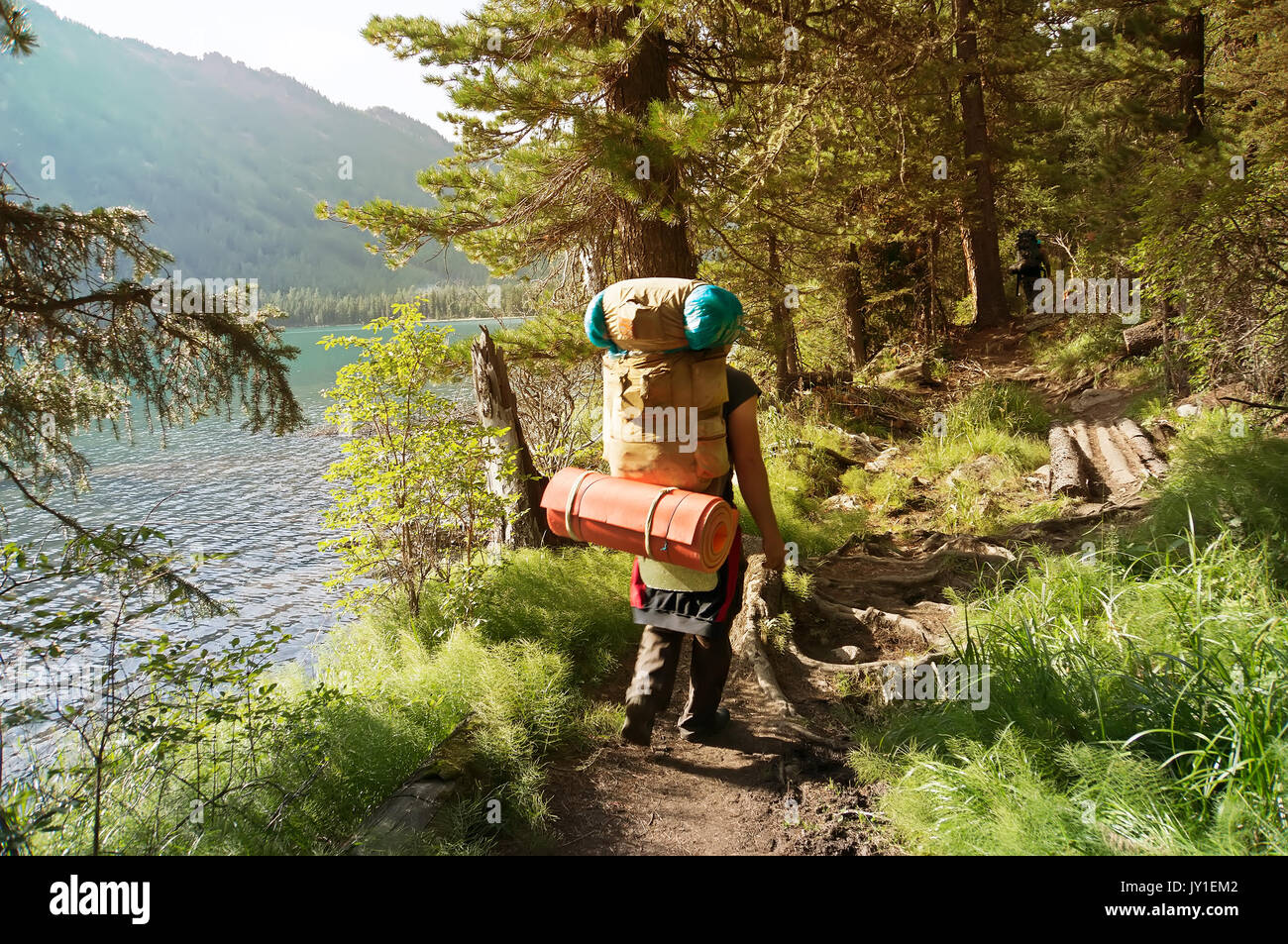 A backpacker with a large backpack. Group of travelers with backpacks ...