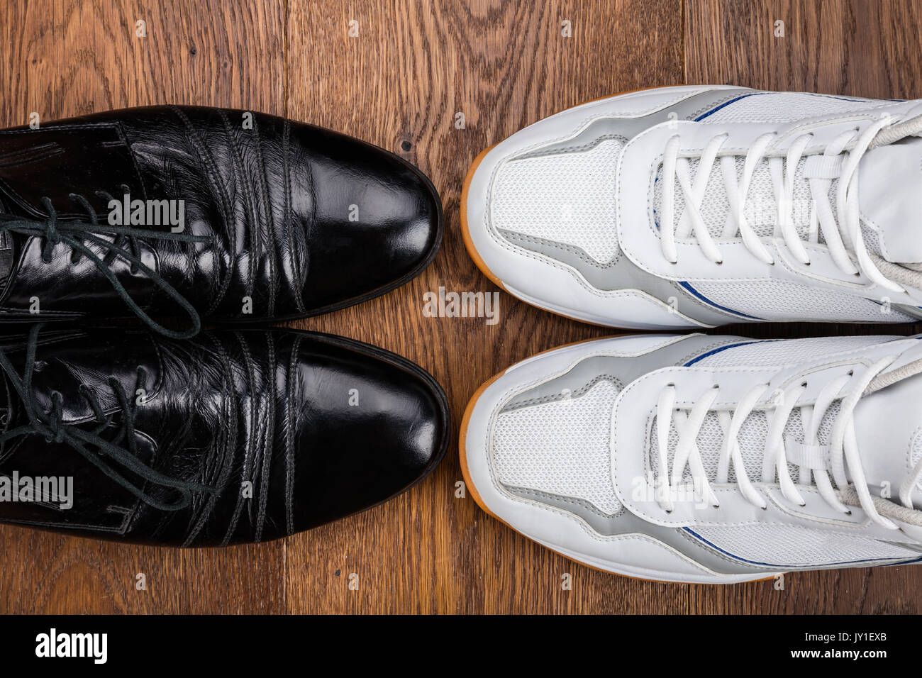 High Angle View Of Pair Of White And Black Shoes Arranged On Wooden ...