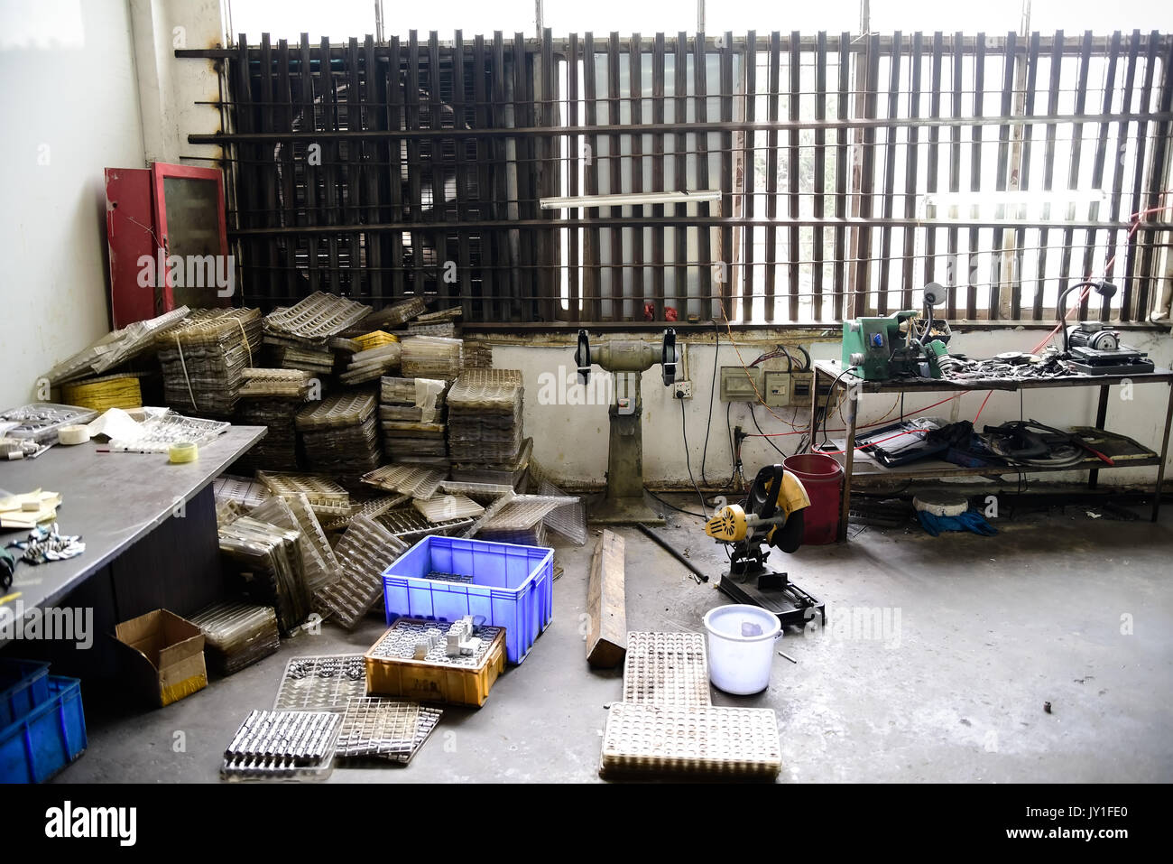 Messy part of workshop at old factory Stock Photo - Alamy