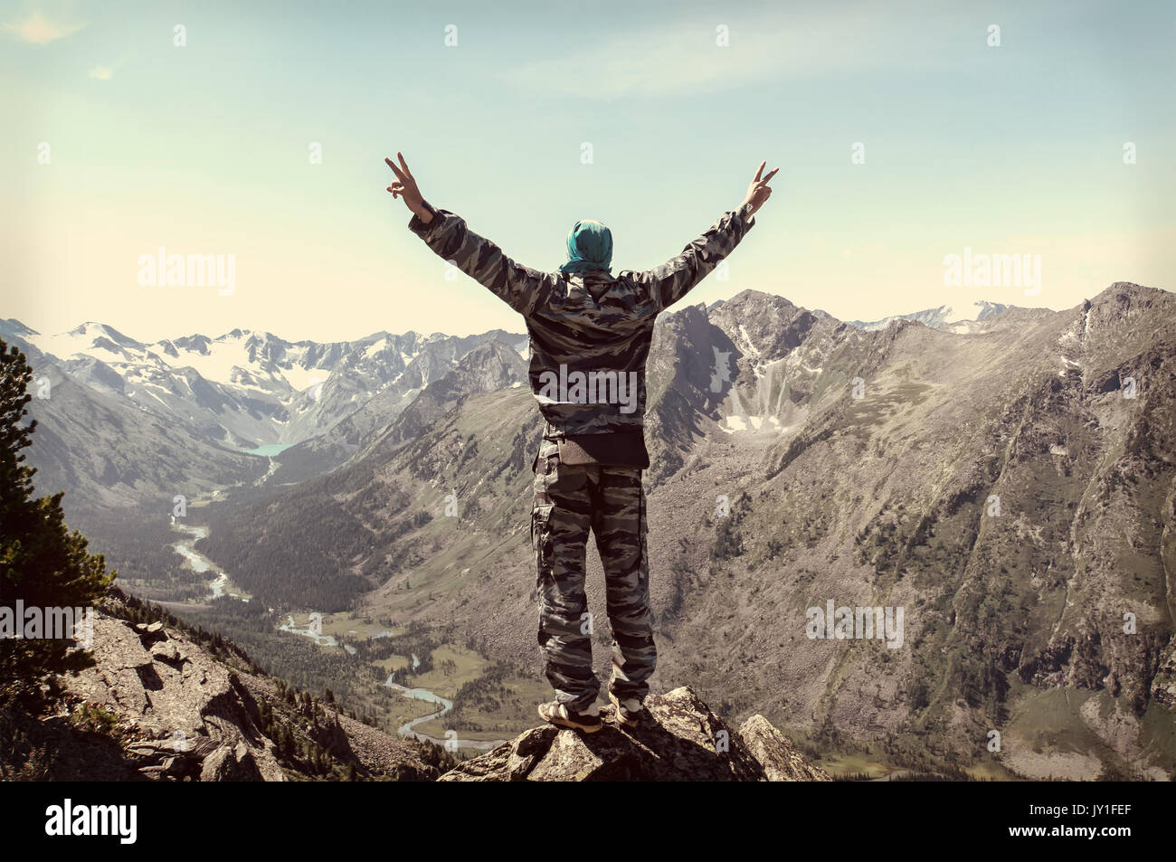 Crazy hiker standing on top of a mountain. Tourist enjoying life on ...