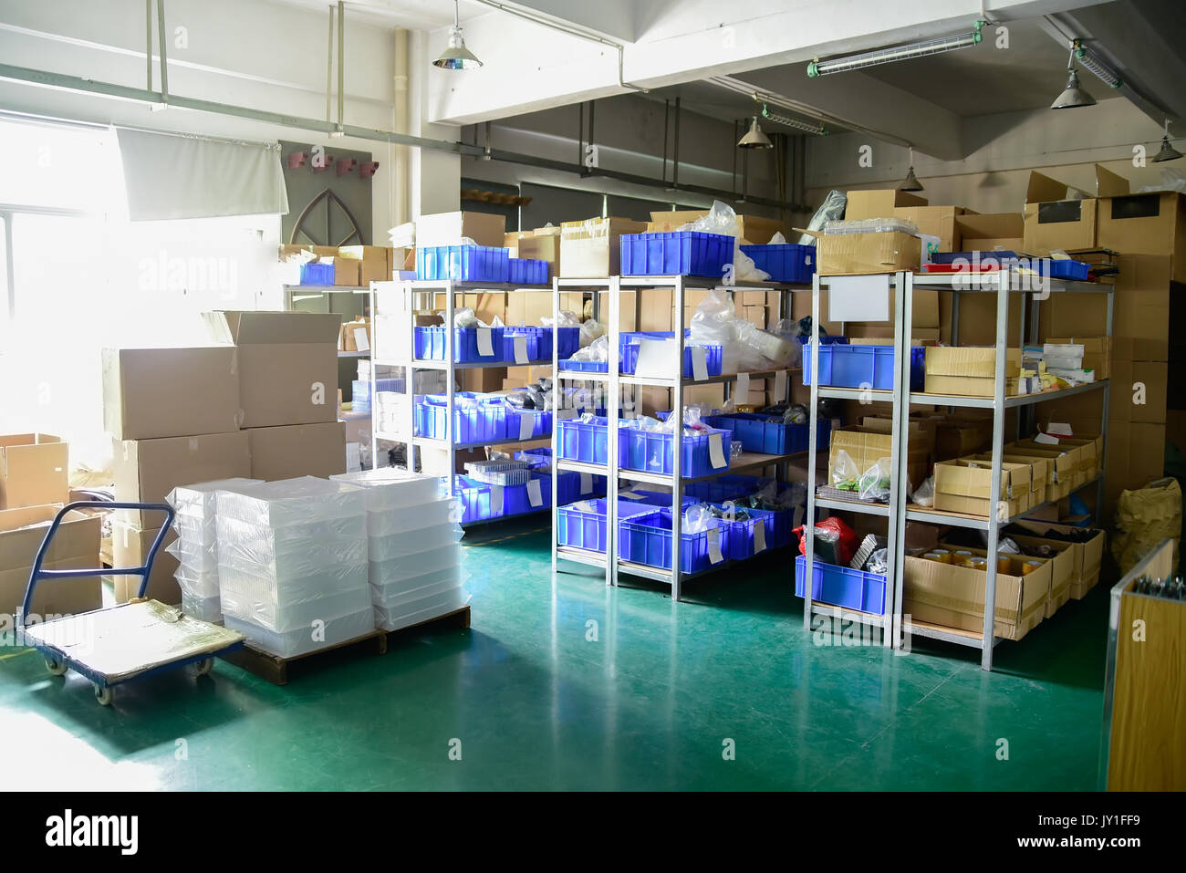 View on empty warehouse of small factory Stock Photo - Alamy