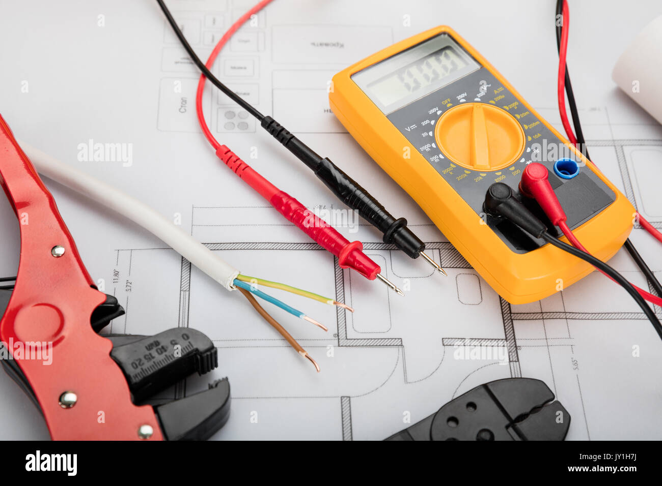 High Angle View Of Digital Multimeter On Blueprint With Red And Black ...
