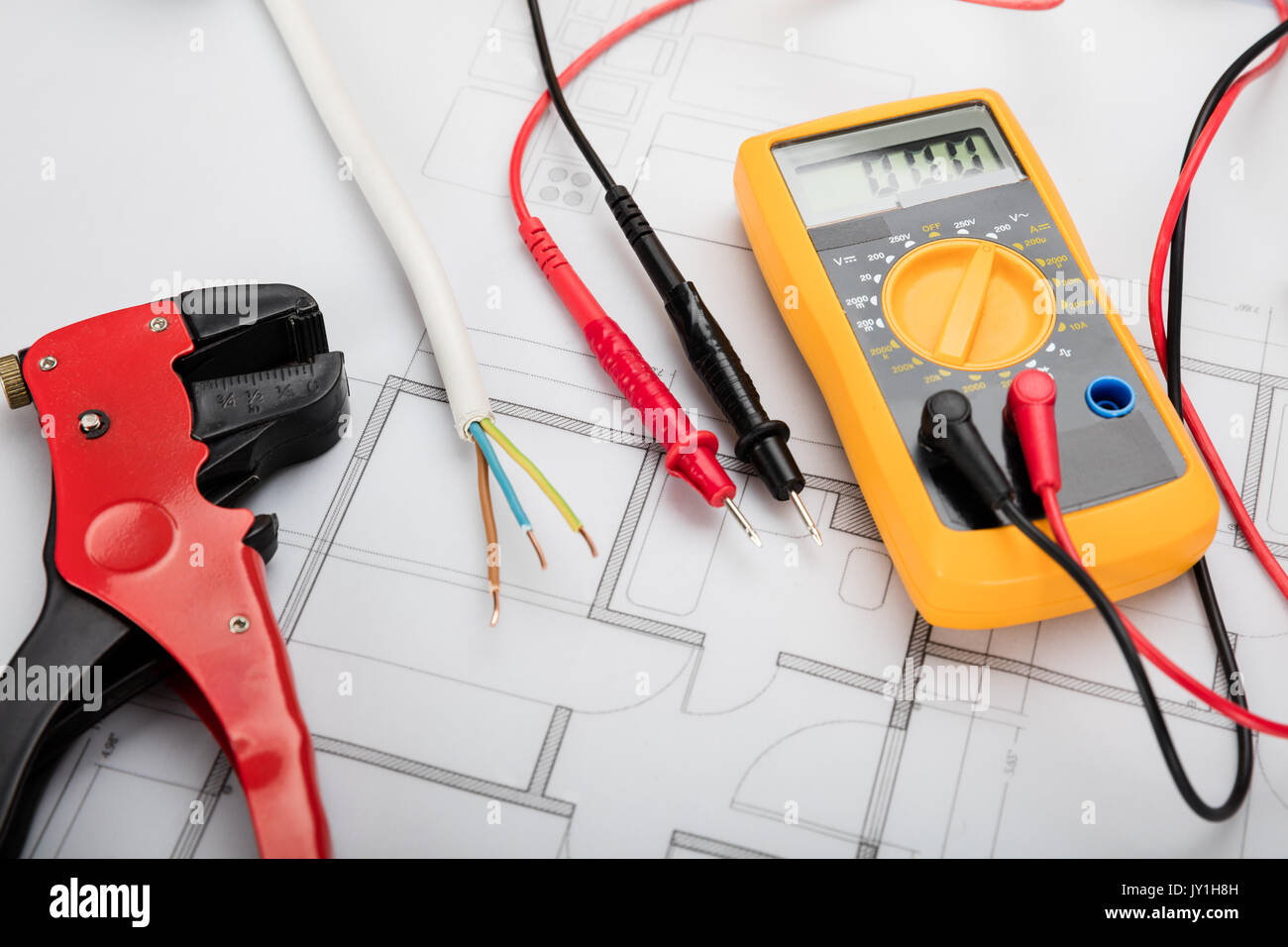High Angle View Of Digital Multimeter On Blueprint With Red And Black ...