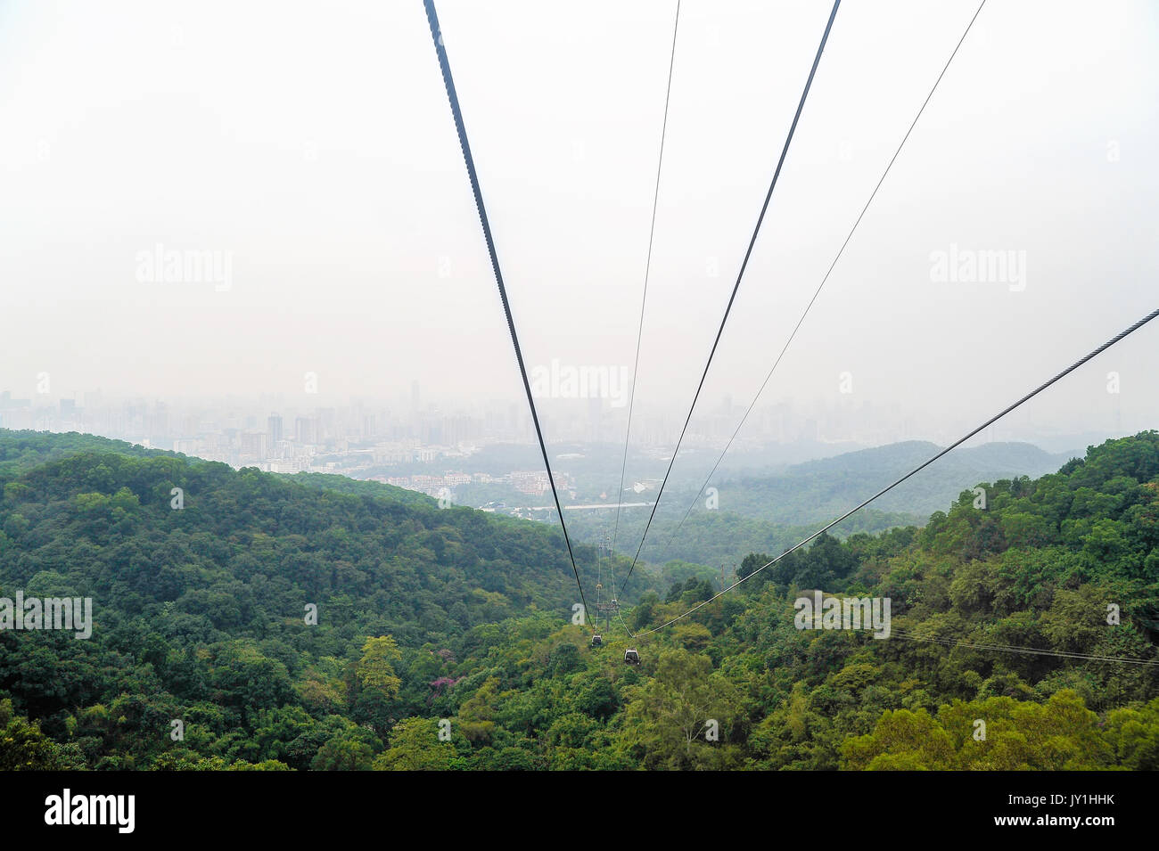 Cable car ropes on city background in Bayun mountain, Guangzhou, China ...