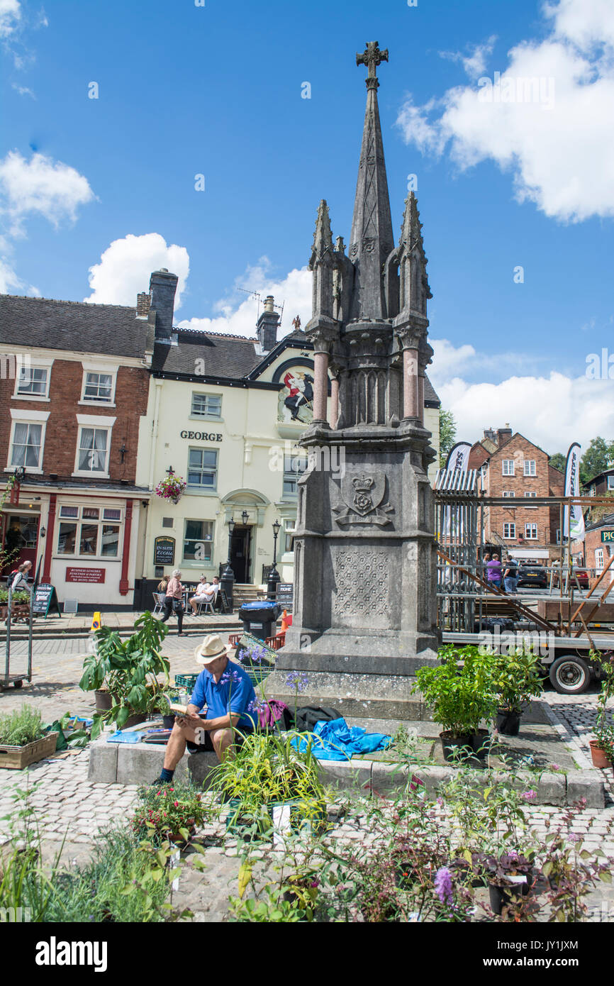 Market trader sits at the bottom the the memorial in Market Place in ...