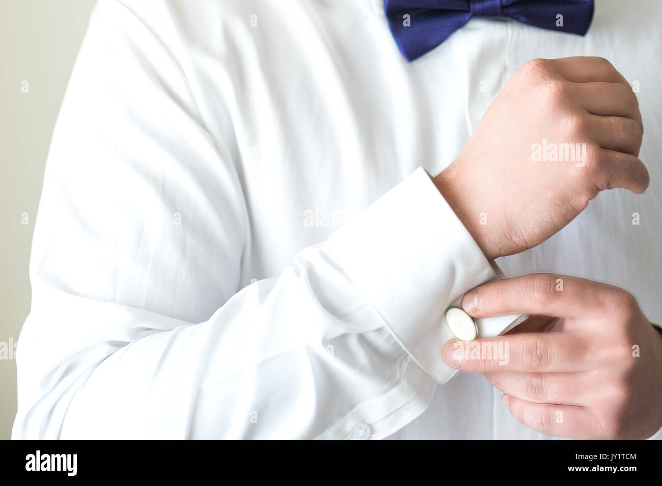 Man fastening a cuff Stock Photo - Alamy