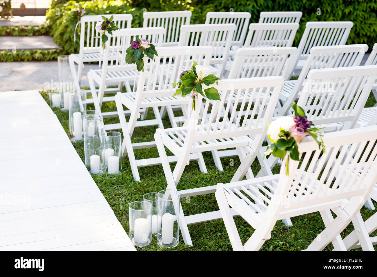 Beautiful wedding set up. Wedding ceremony in the garden. White wooden ...